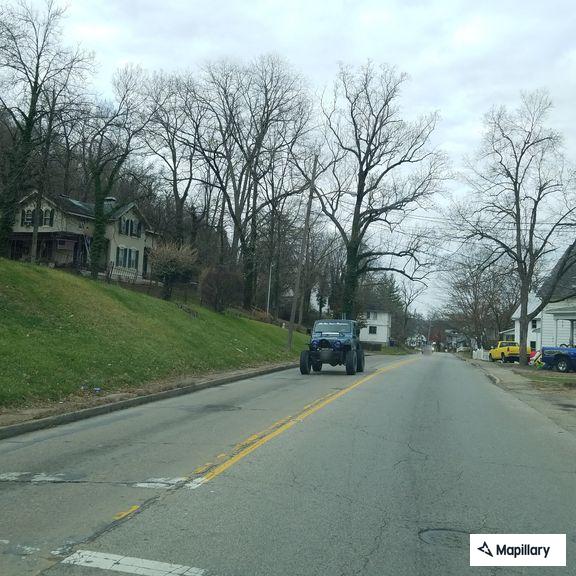 Man running eastbound near State Route 104 from sedan, Columbus OH ...