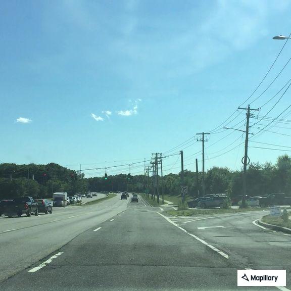 Tan van disabled on highway shoulder with driver crossing, Suffolk ...