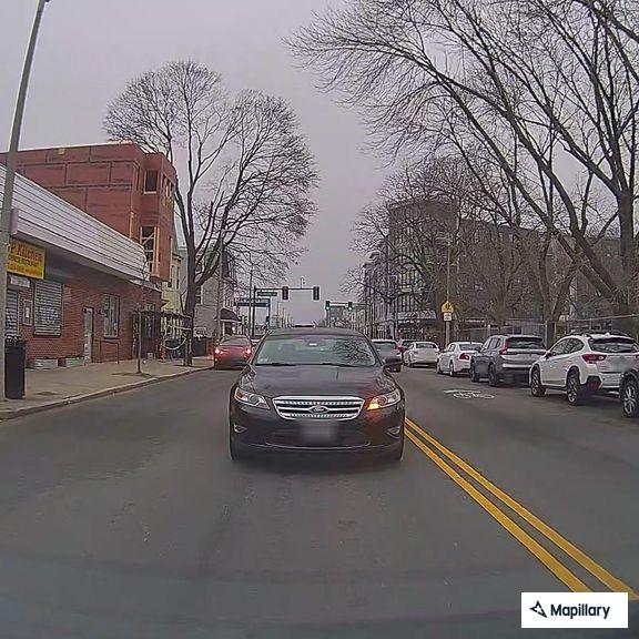 Multiple mopeds weave through traffic near transit station, Boston MA ...